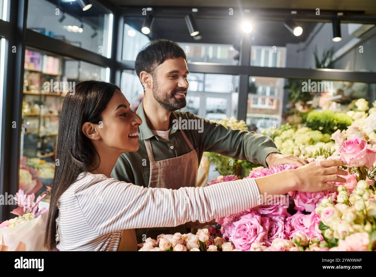 A dedicated couple expertly arranging vibrant flowers together in their ...