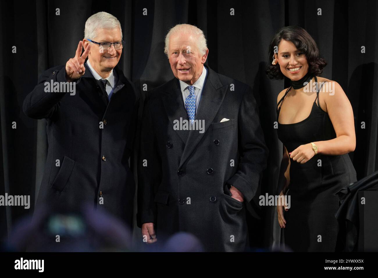 Britain's King Charles III, centre looks up as British singer Raye ...