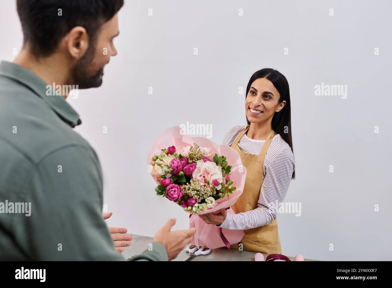 Florist engages with a man to help choose the perfect floral ...