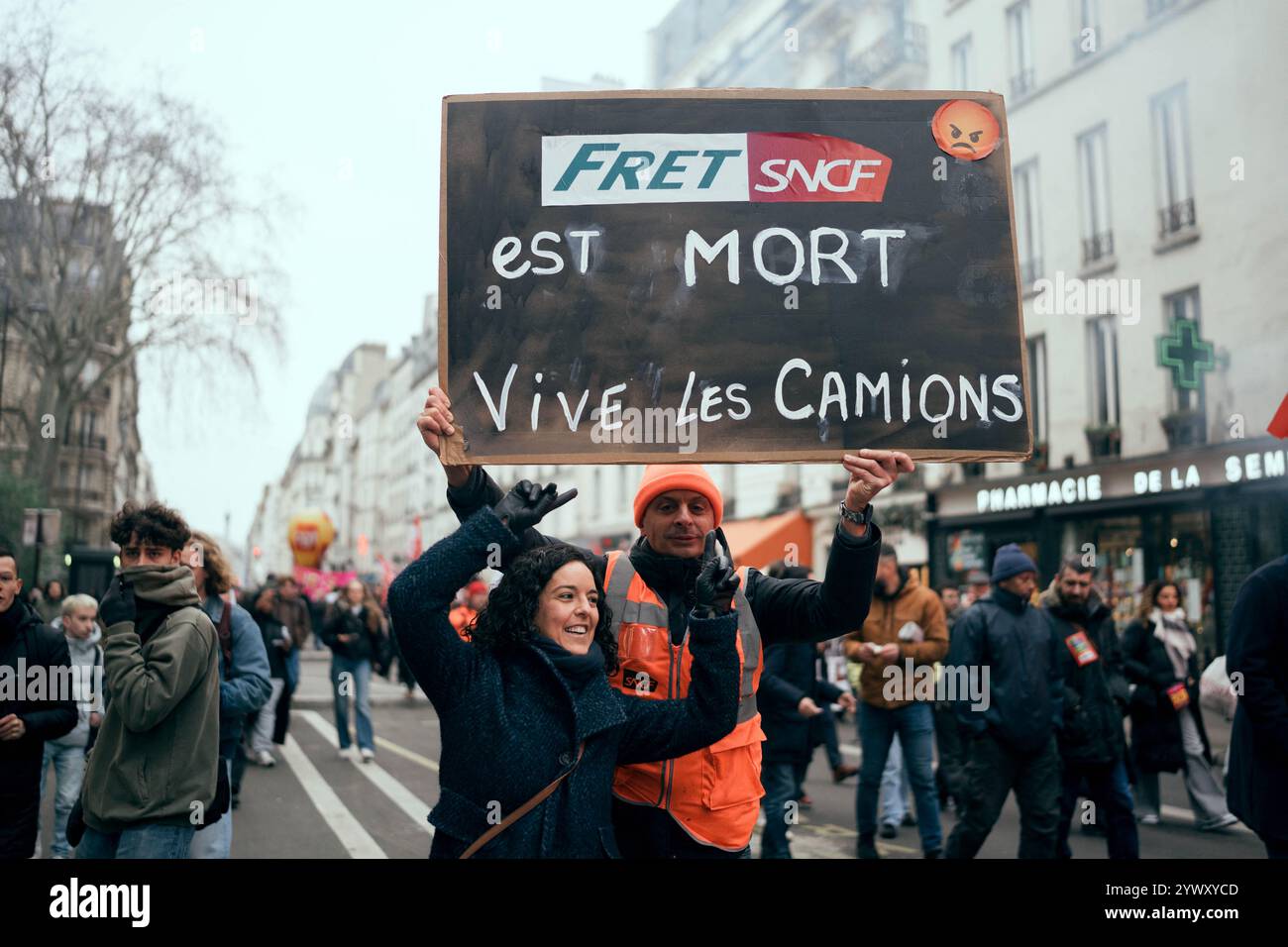 A protestor holds a sign reading "Sncf freight is dead - Long live the ...