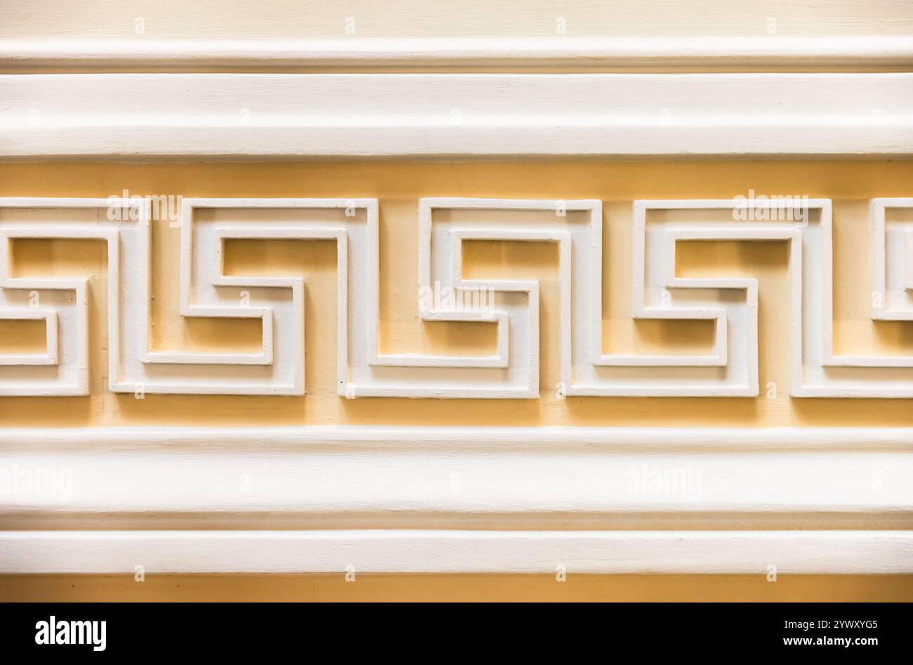 Decoration with white Meander motif over yellow backdrop. Classic wall ...
