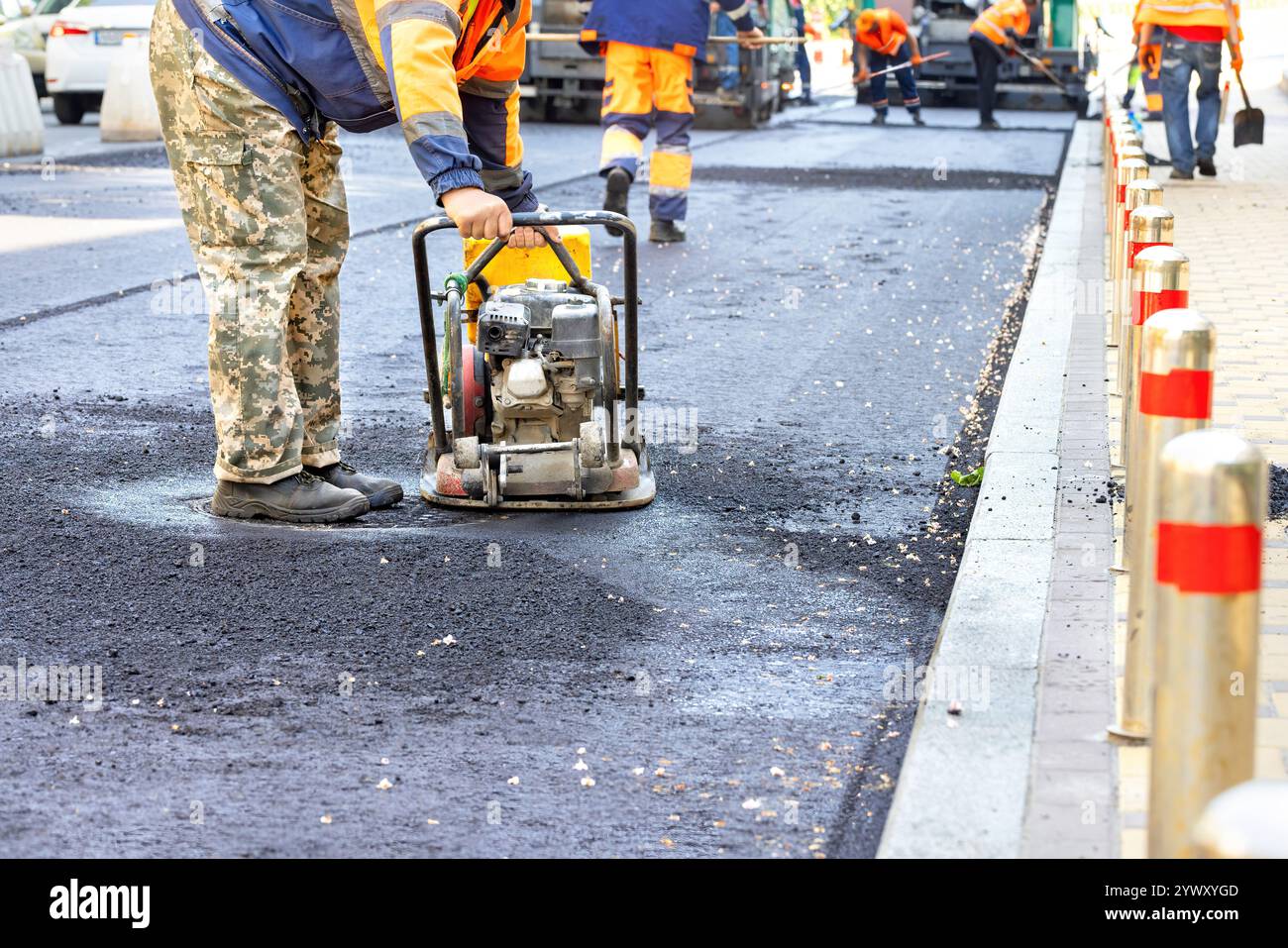 Road construction crew working diligently on a new asphalt surface in ...