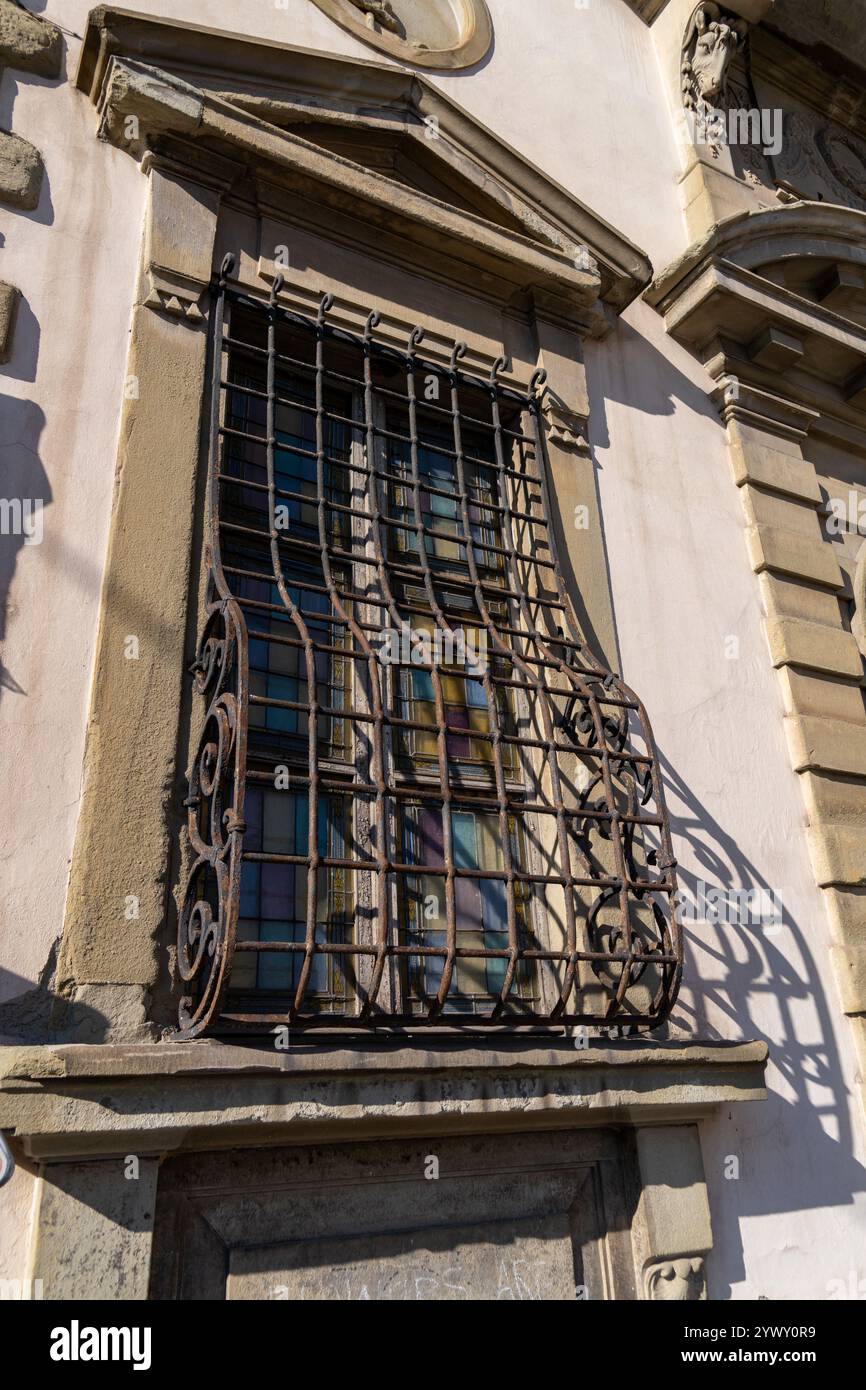 An ornate cast iron window grate on a building with Renaissance ...