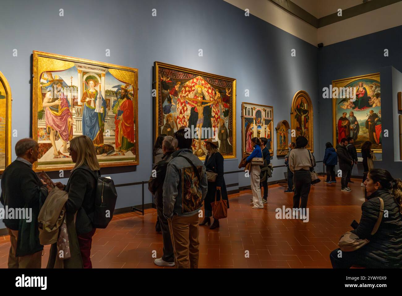 Visitors viewing Renaissance paintings in an exhibition hall in the ...