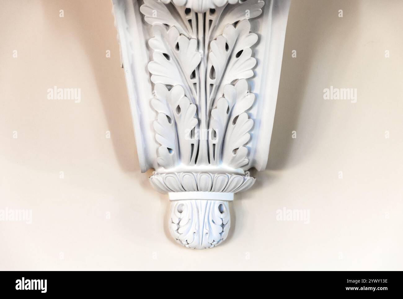 White gypsum bas-relief decoration with floral pattern. Classic wall ...