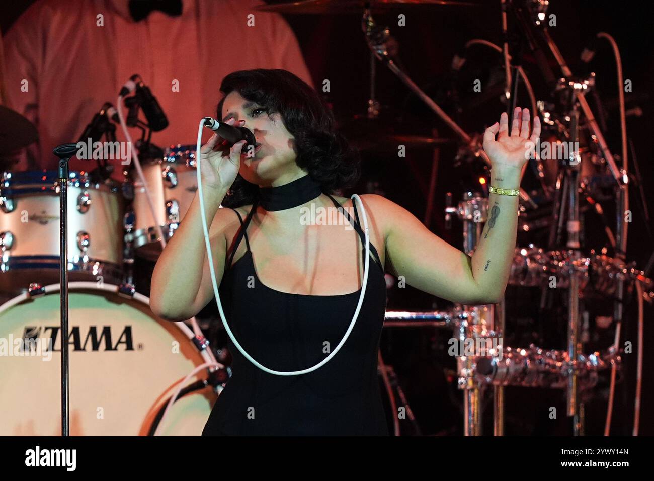 Raye performing at a plaque unveiling during a tour by King Charles III ...