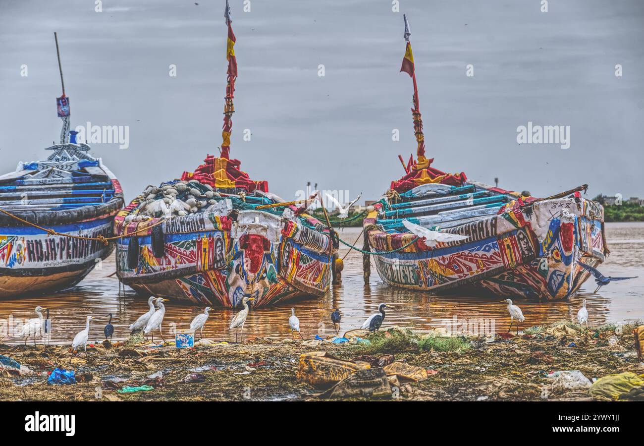 colorful fisher boats are aligned on the shore, with all kind of water ...