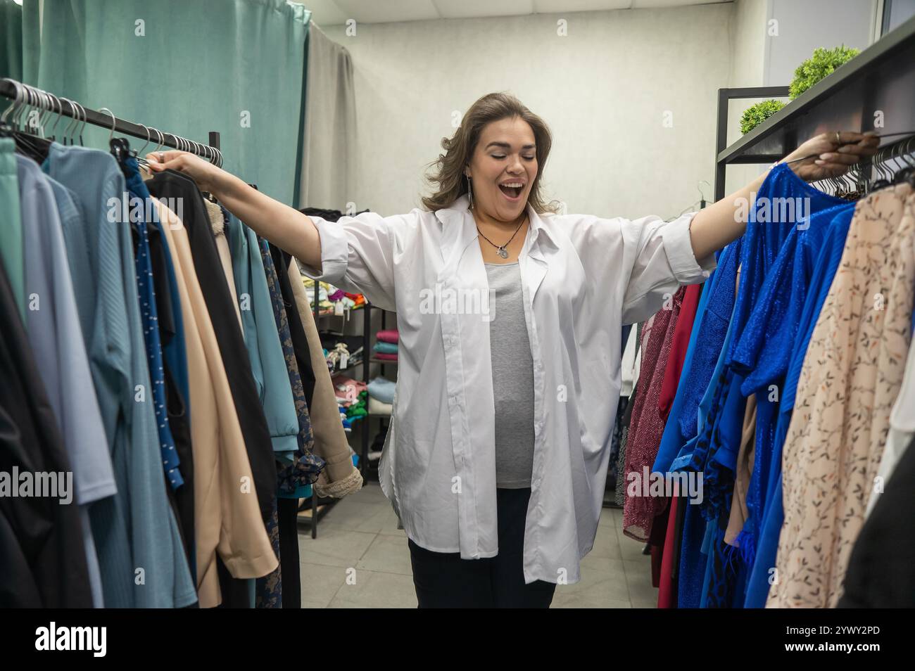 A fat woman chooses clothes in a plus size store Stock Photo - Alamy
