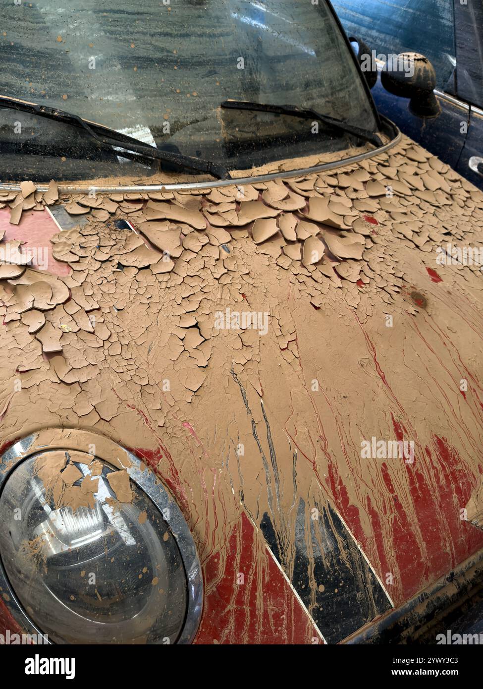Numerous cars covered in mud and debris after severe flooding in Stock ...