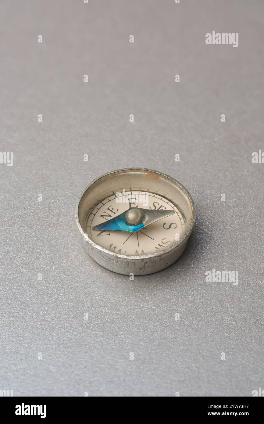 small round vintage pocket compass isolated on gray textured background ...