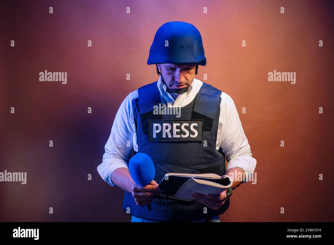 Reporter with bulletproof vest holding a microphone in studio Stock ...