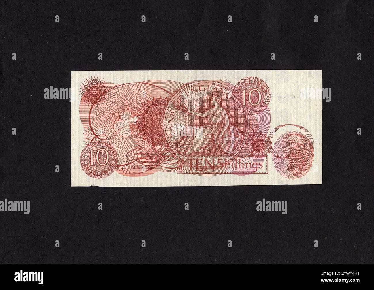 The back of a vintage ten shilling note from Great Britain on a black ...