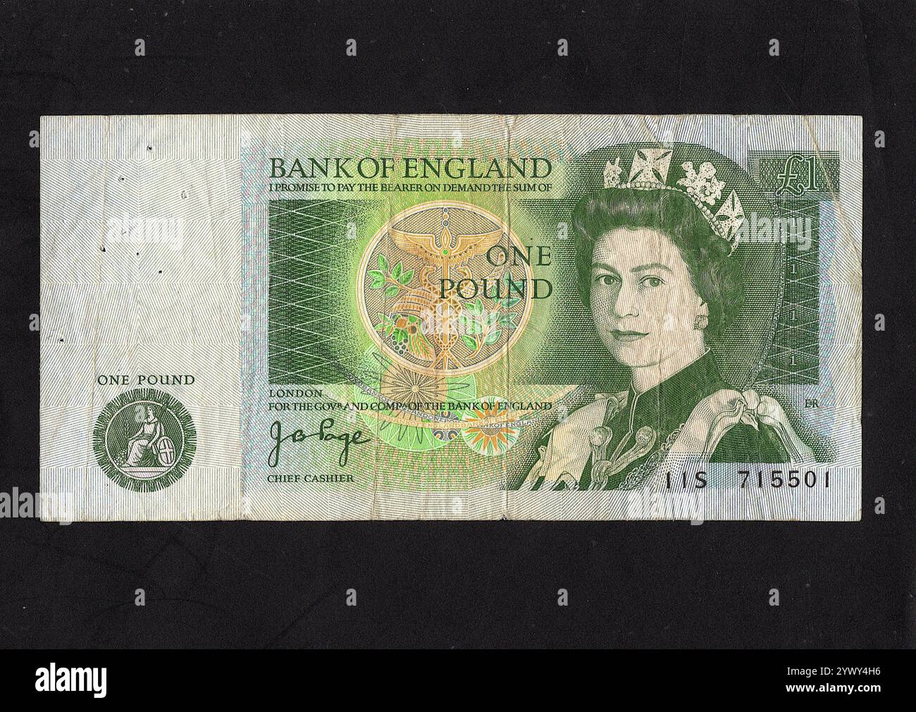 The front of a vintage one pound note from Great Britain on a black ...
