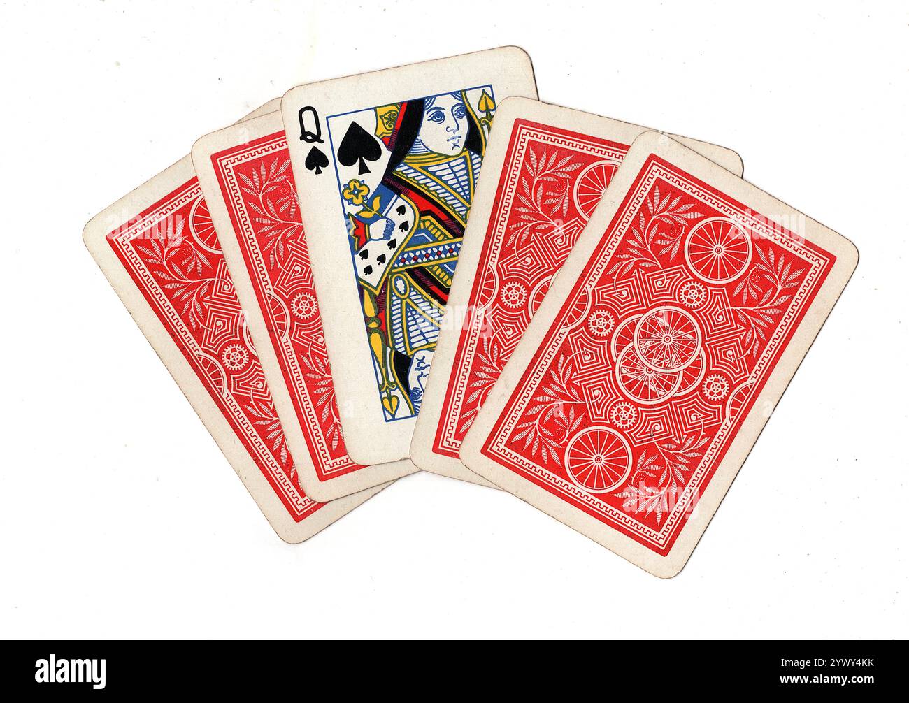 A hand of vintage playing card backs with the queen of spades revealed ...