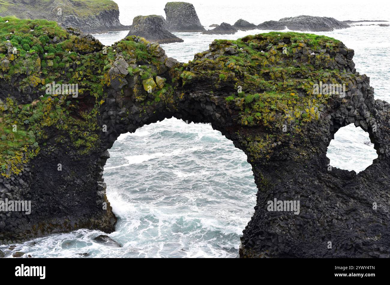 Arnarstapi cliffs with birds colonies. Natural arch and window ...