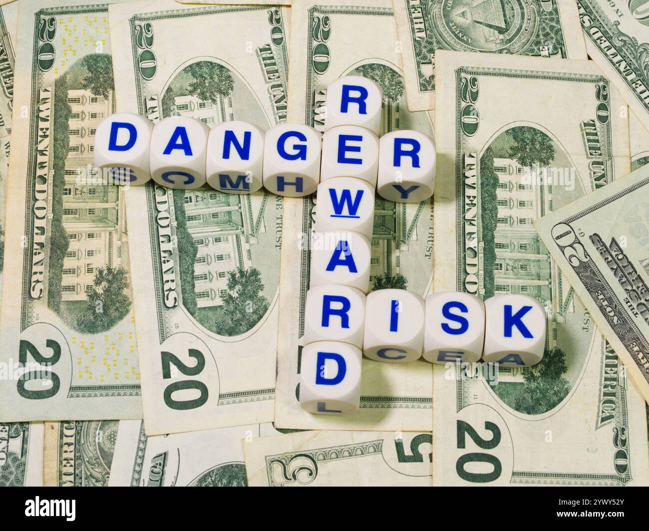 Closeup overhead concept shot of the letter dice words - danger, reward ...