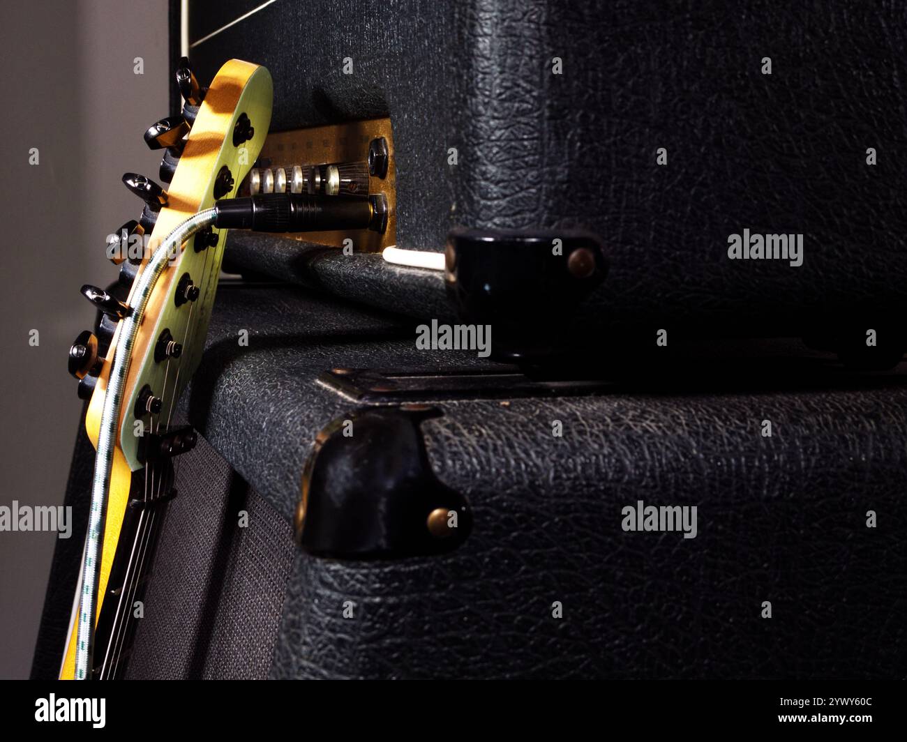 Closeup of the top of an electric guitar leaning against a vintage ...