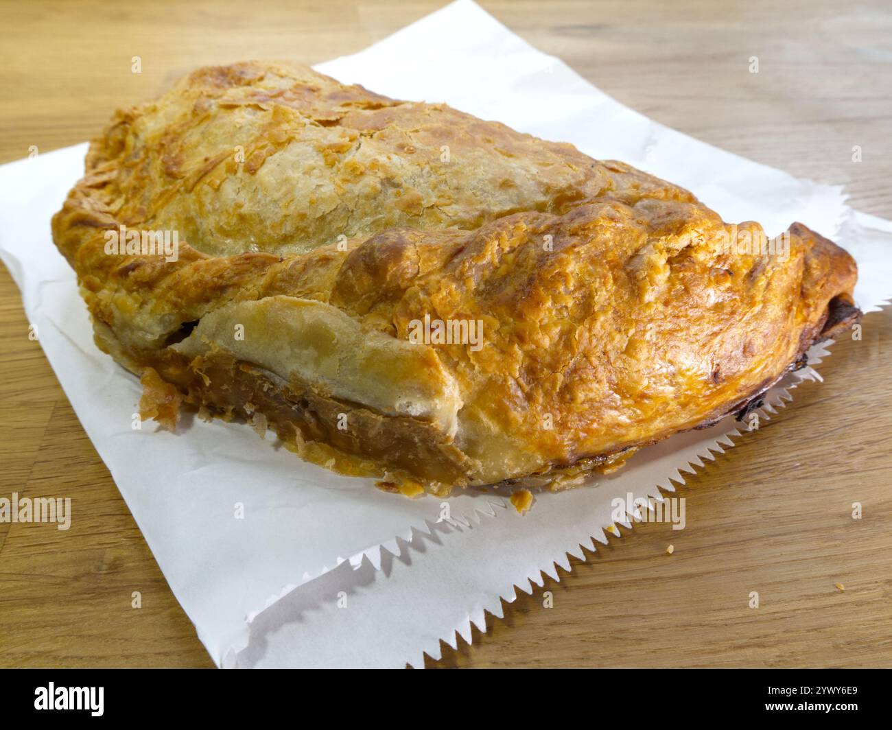 Closeup of a traditional baked Cornish pasty with meat and vegetable ...