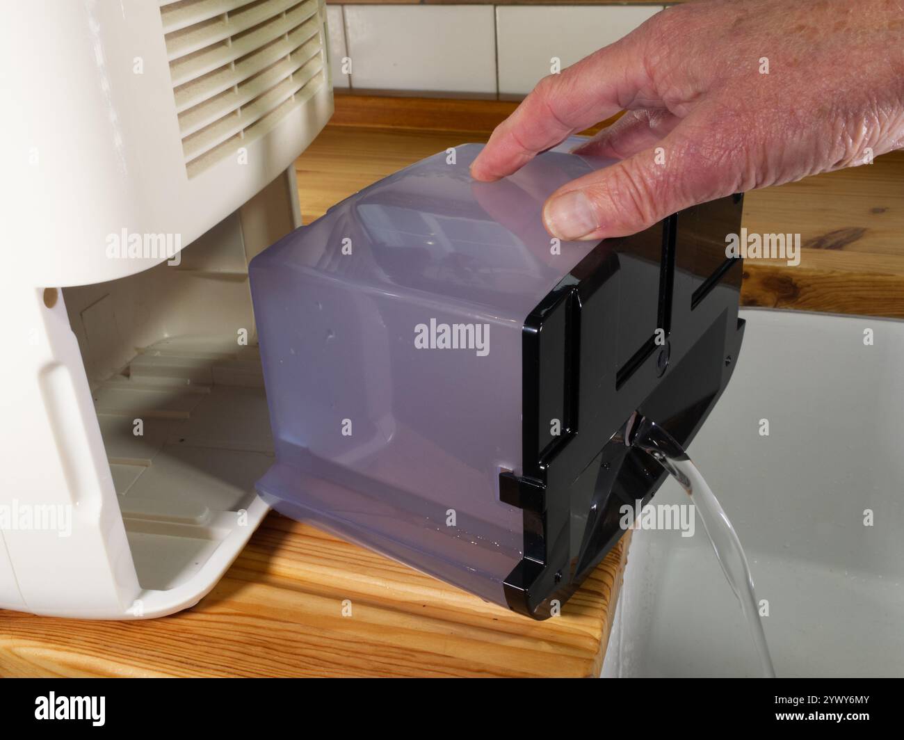 Closeup of a dehumidifier or air conditioner next to its waste tank ...