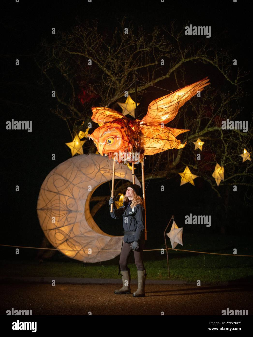 Freya, a puppeteer flies an owl along the trail of Wild Glow, a winter ...