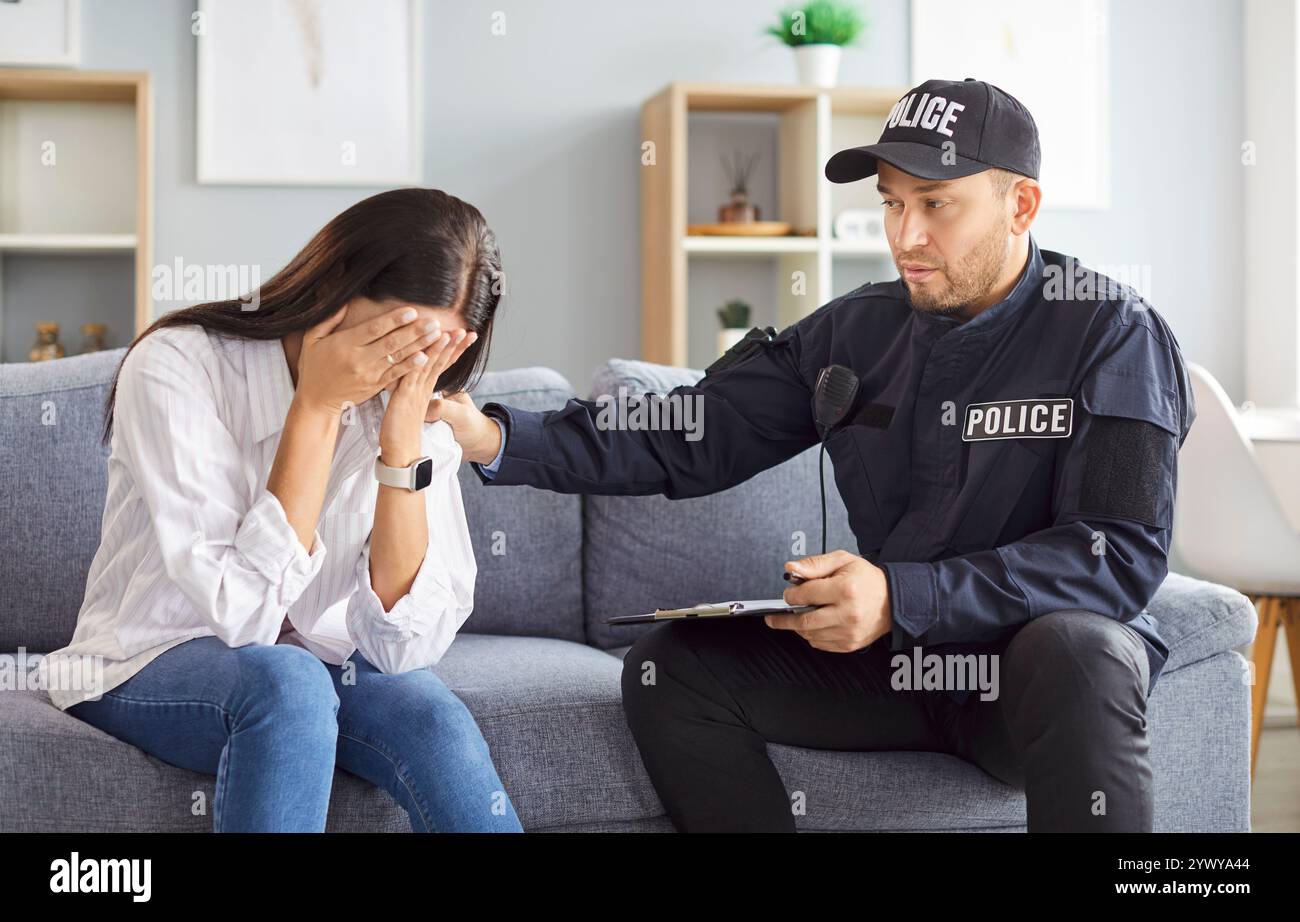 Police officer talking to female robbery victim after burglary sitting ...