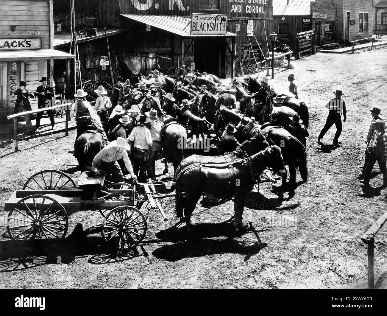 Harry Carey, Walter Huston (with rifles fending off mob), on-set of the ...