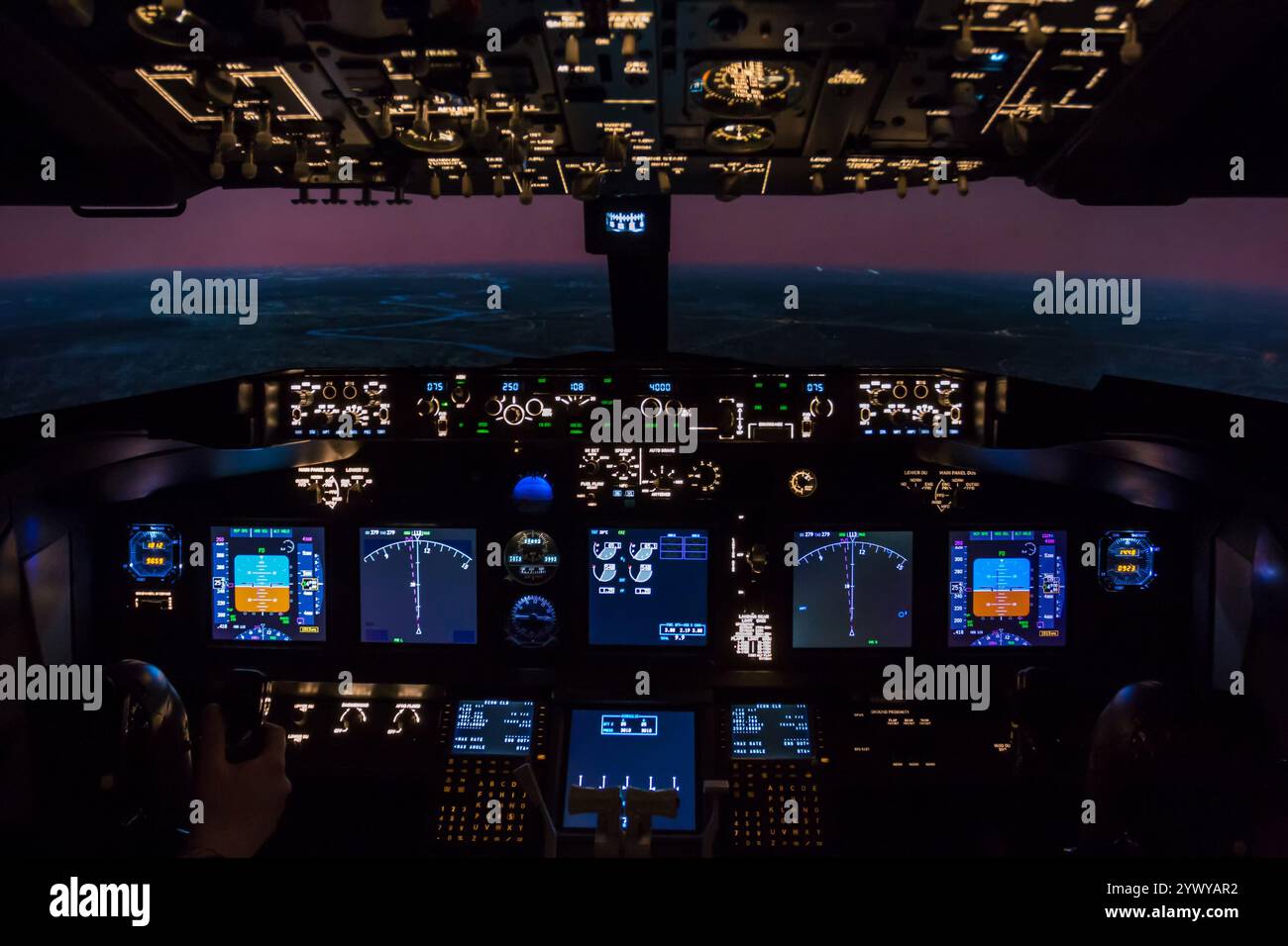 Inside the cockpit of a passenger aircraft flying at dusk Stock Photo ...
