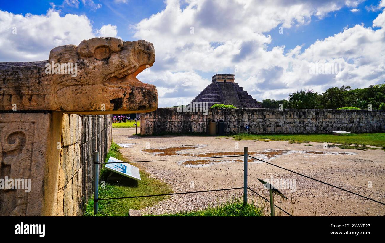 Kukulcan Serpent head sculpture close up with a view of the Great ...