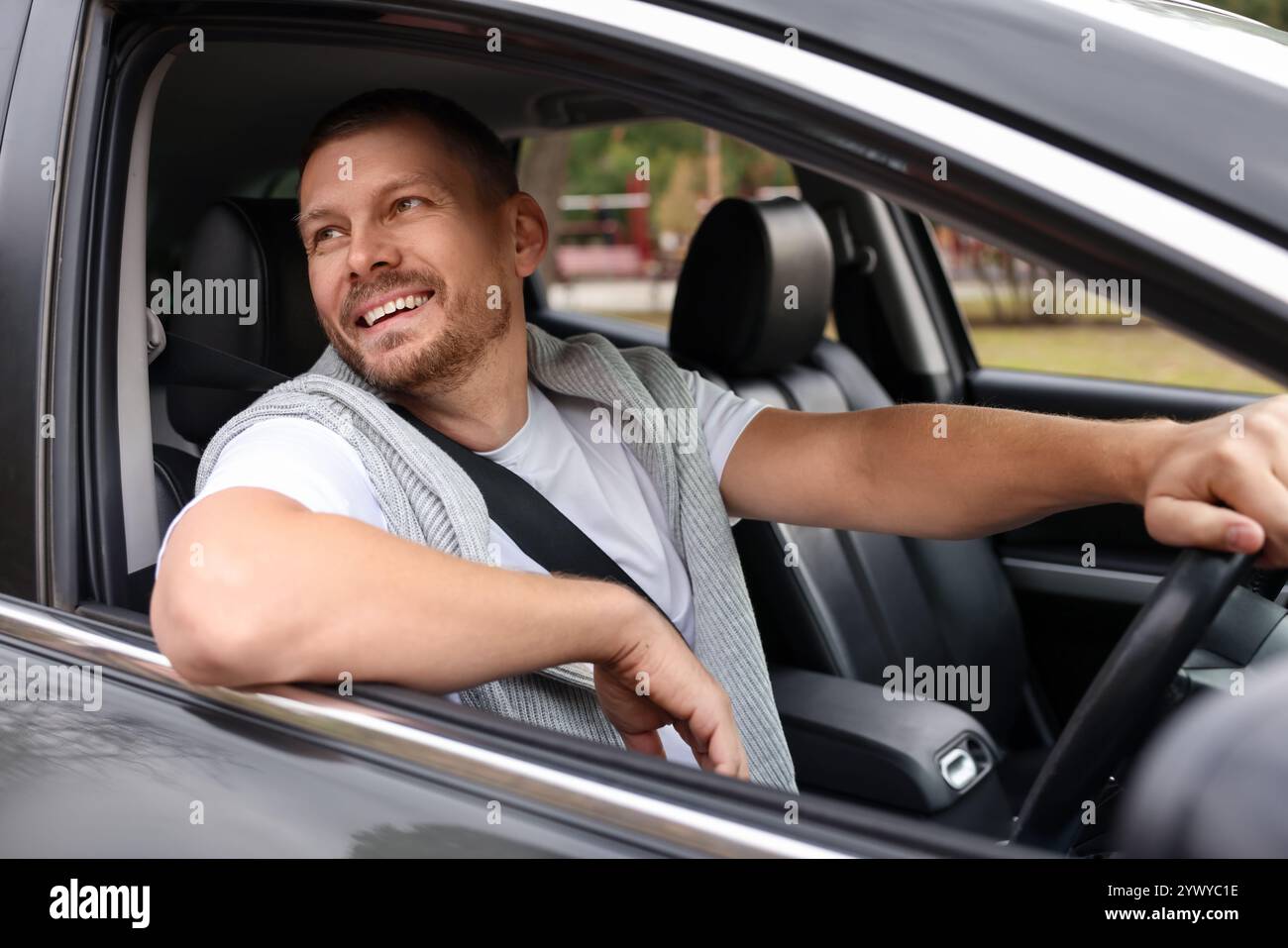 Man driving modern car, view through window Stock Photo - Alamy