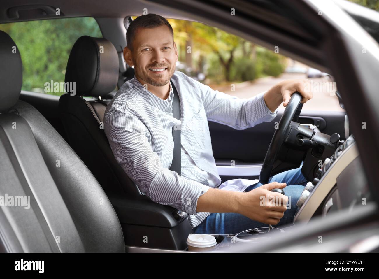 Man driving modern car, view through window Stock Photo - Alamy