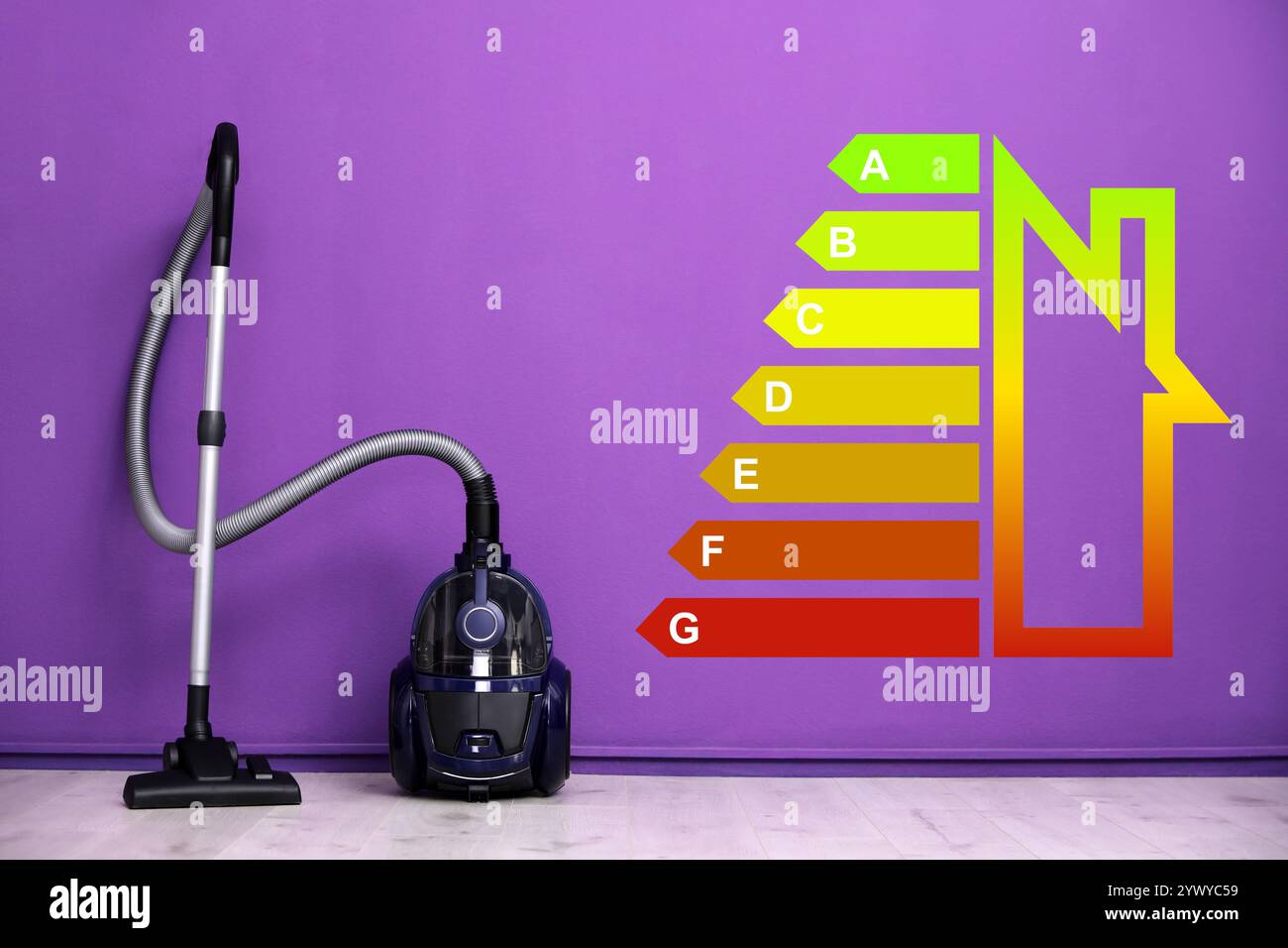 Energy efficiency rating of home appliances. Modern vacuum cleaner near ...