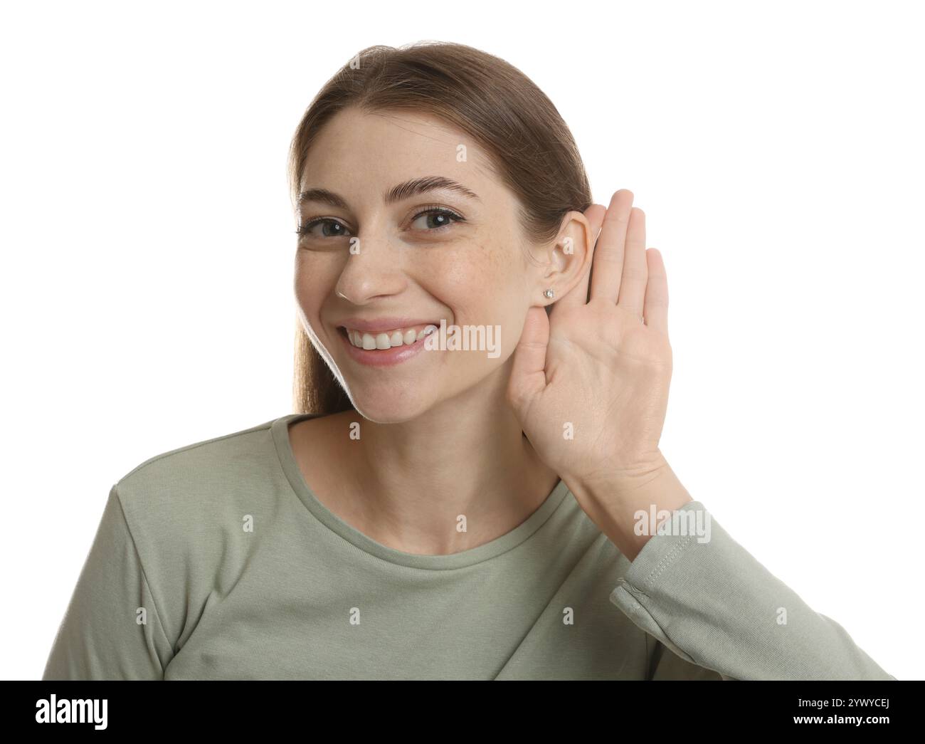 Woman showing hand to ear gesture on white background Stock Photo - Alamy
