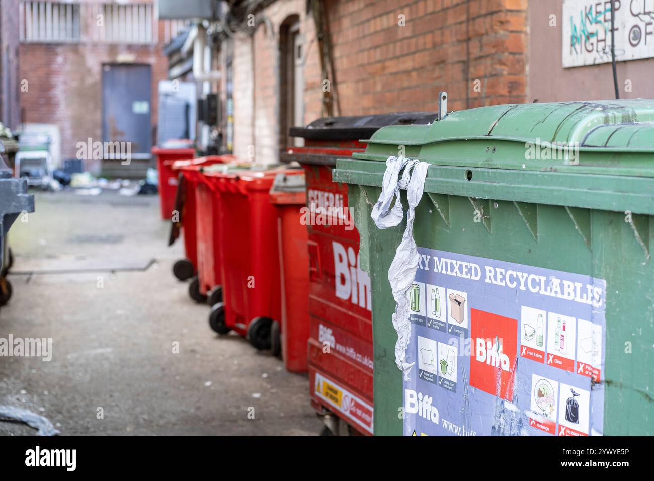Large commercial waste bins in the back alley behind buildings of ...