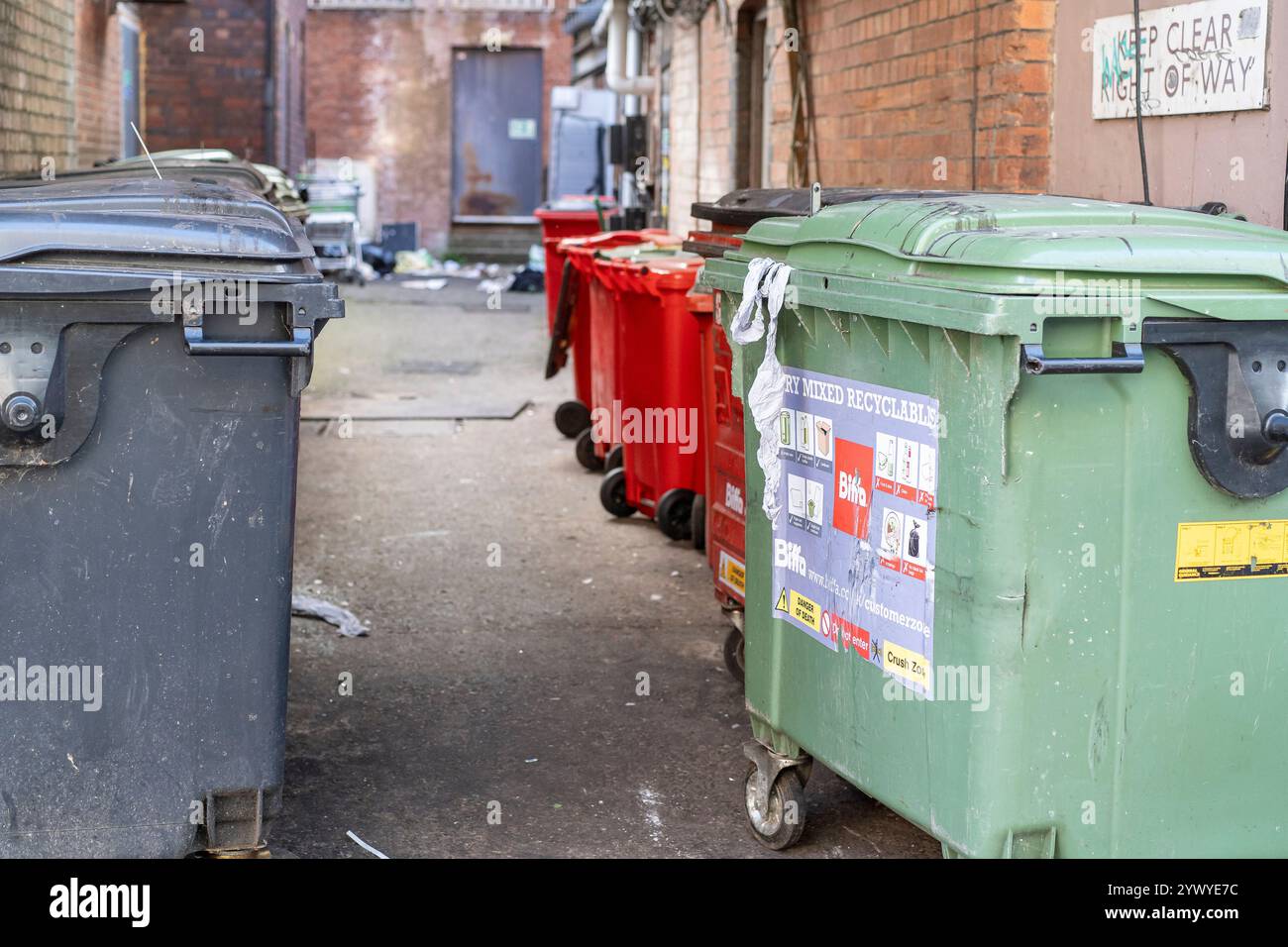 Large commercial waste bins in the back alley behind buildings of ...
