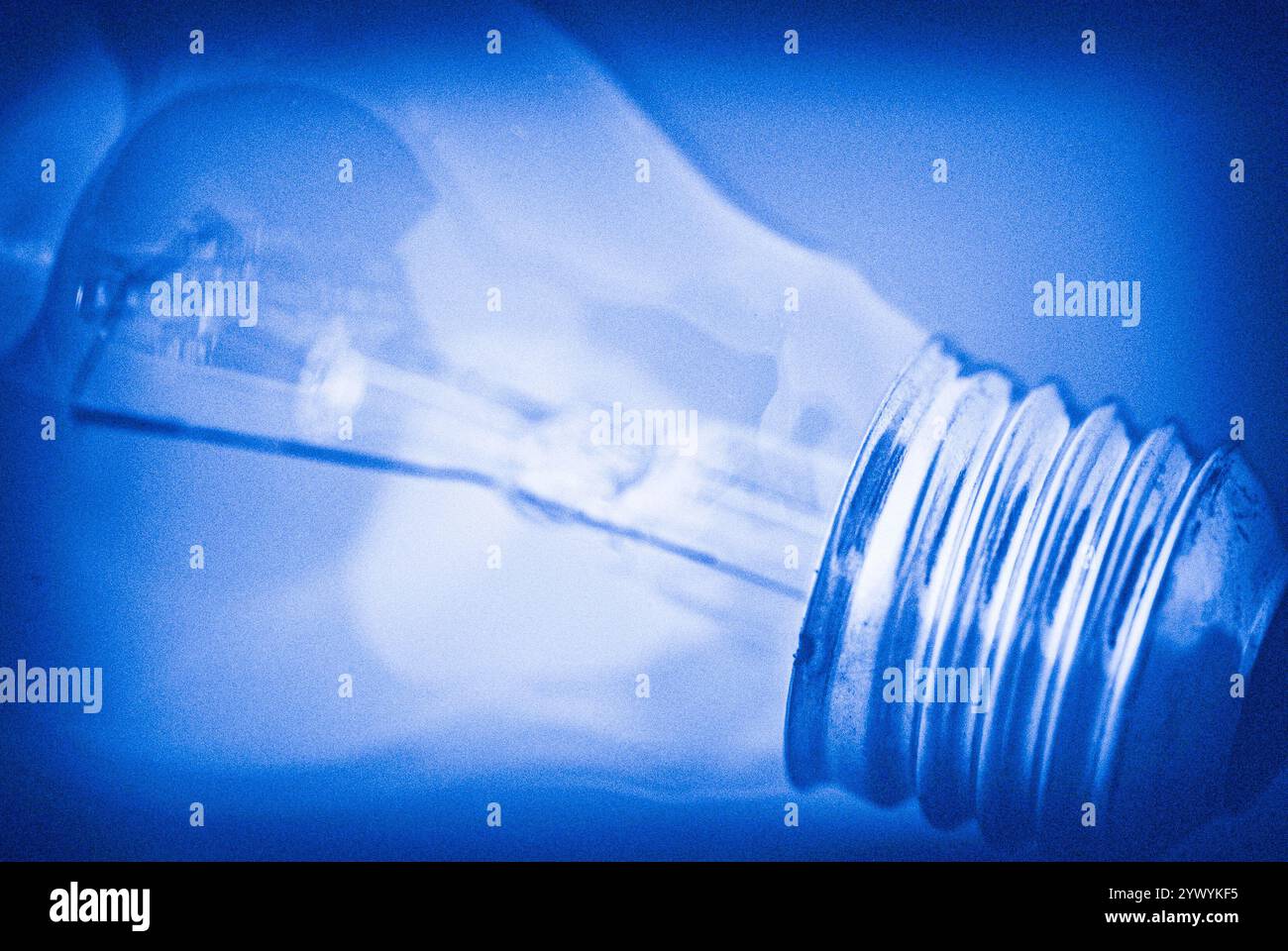 Creative detailed photo of an old light bulb with tungsten filament ...