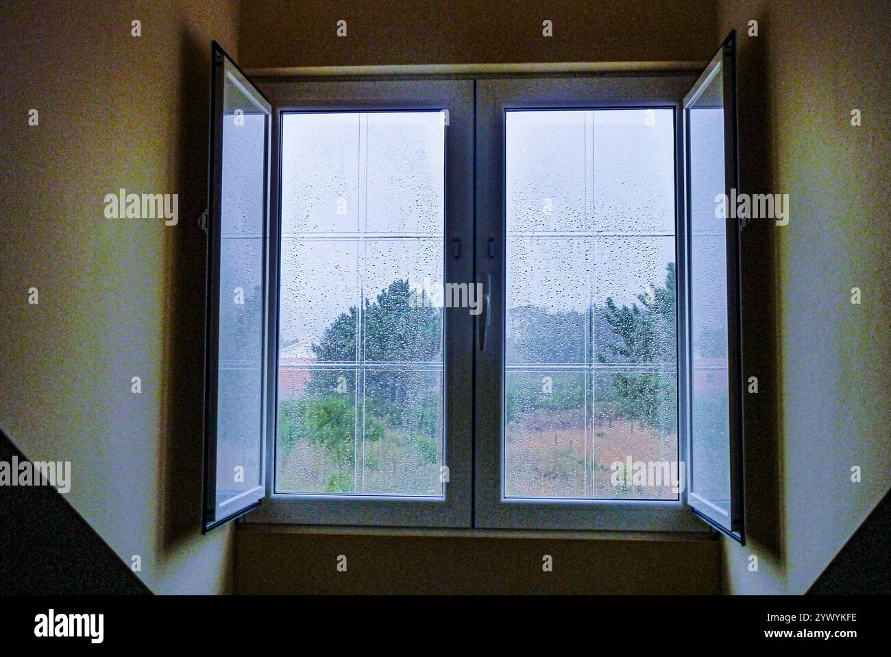 View through a window covered with raindrops on a rainy day in Spain ...