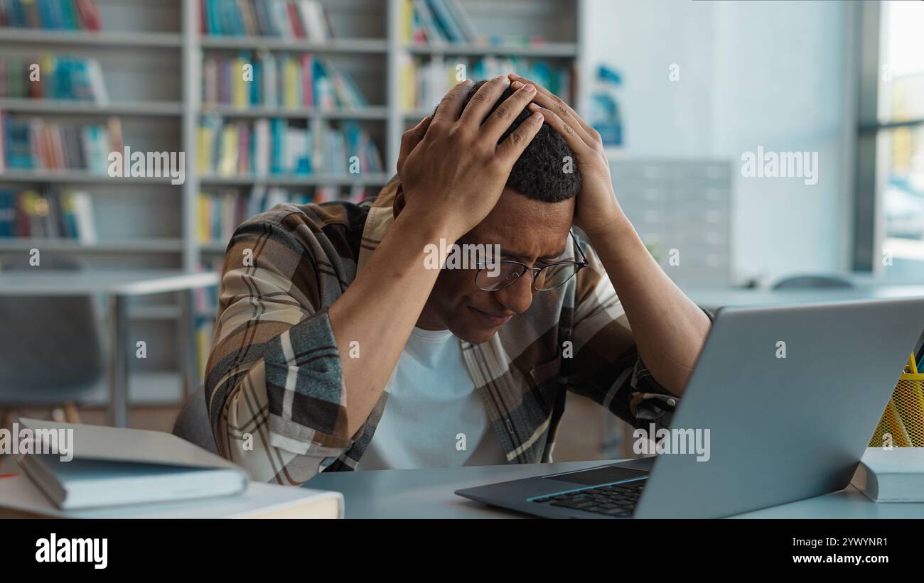 African American man student library laptop desktop computer gadget guy ...