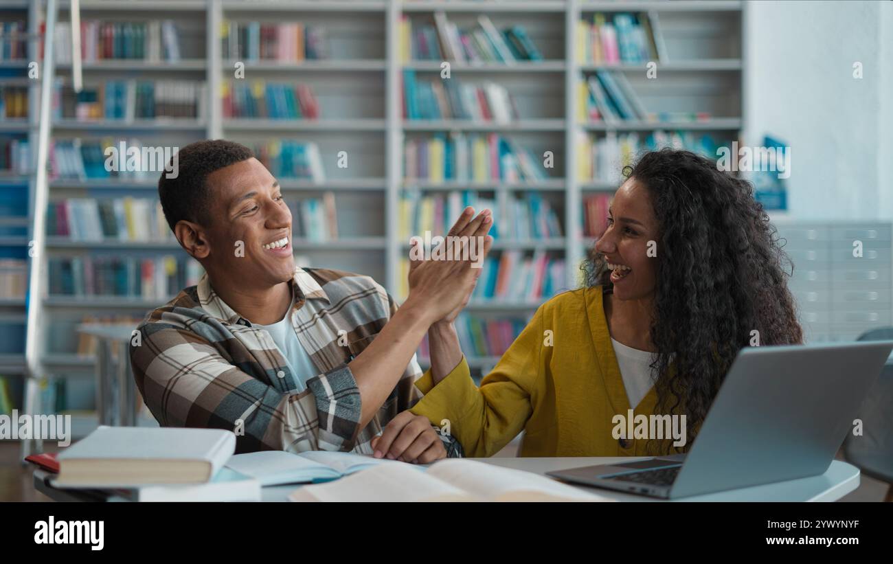 African American man Arab Caucasian woman smile high five together ...
