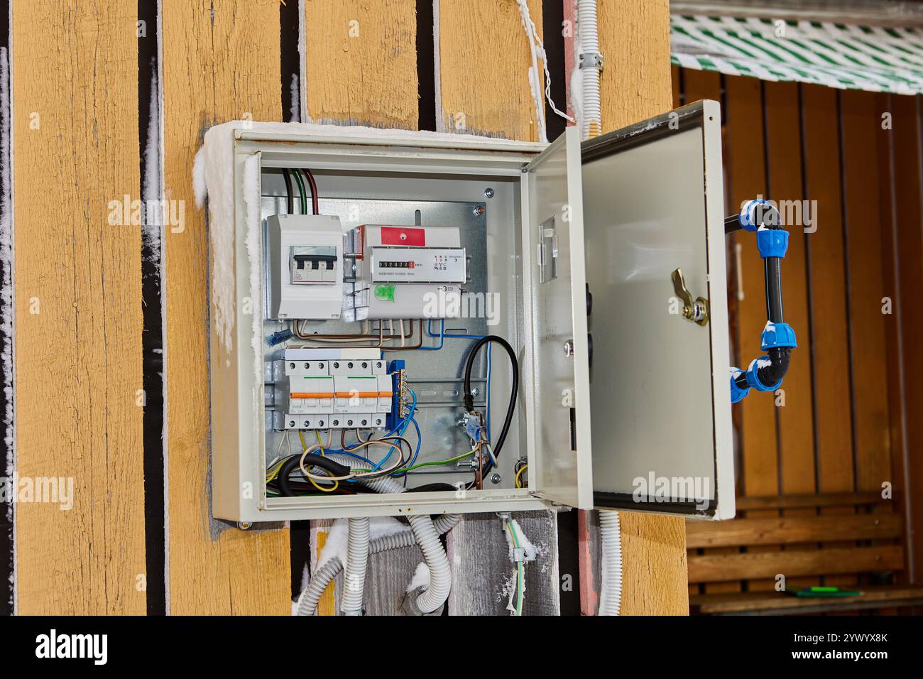 An outdoor metal electrical box with installed circuit breakers and an ...