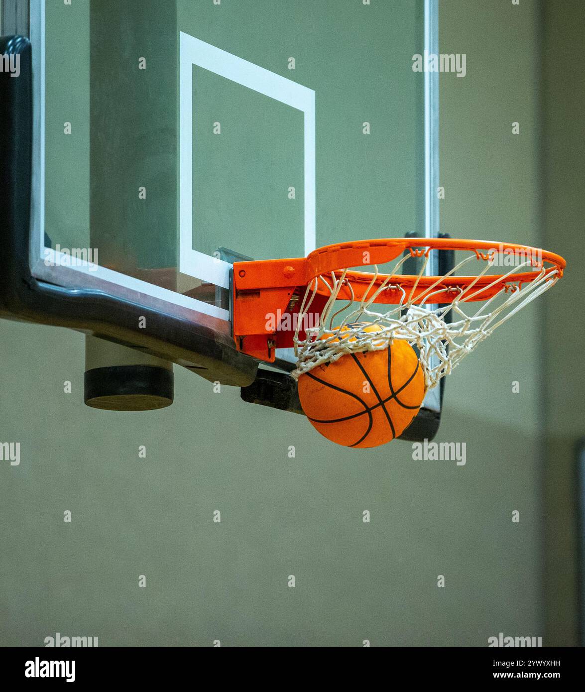 Basketball going through a hoop Stock Photo - Alamy