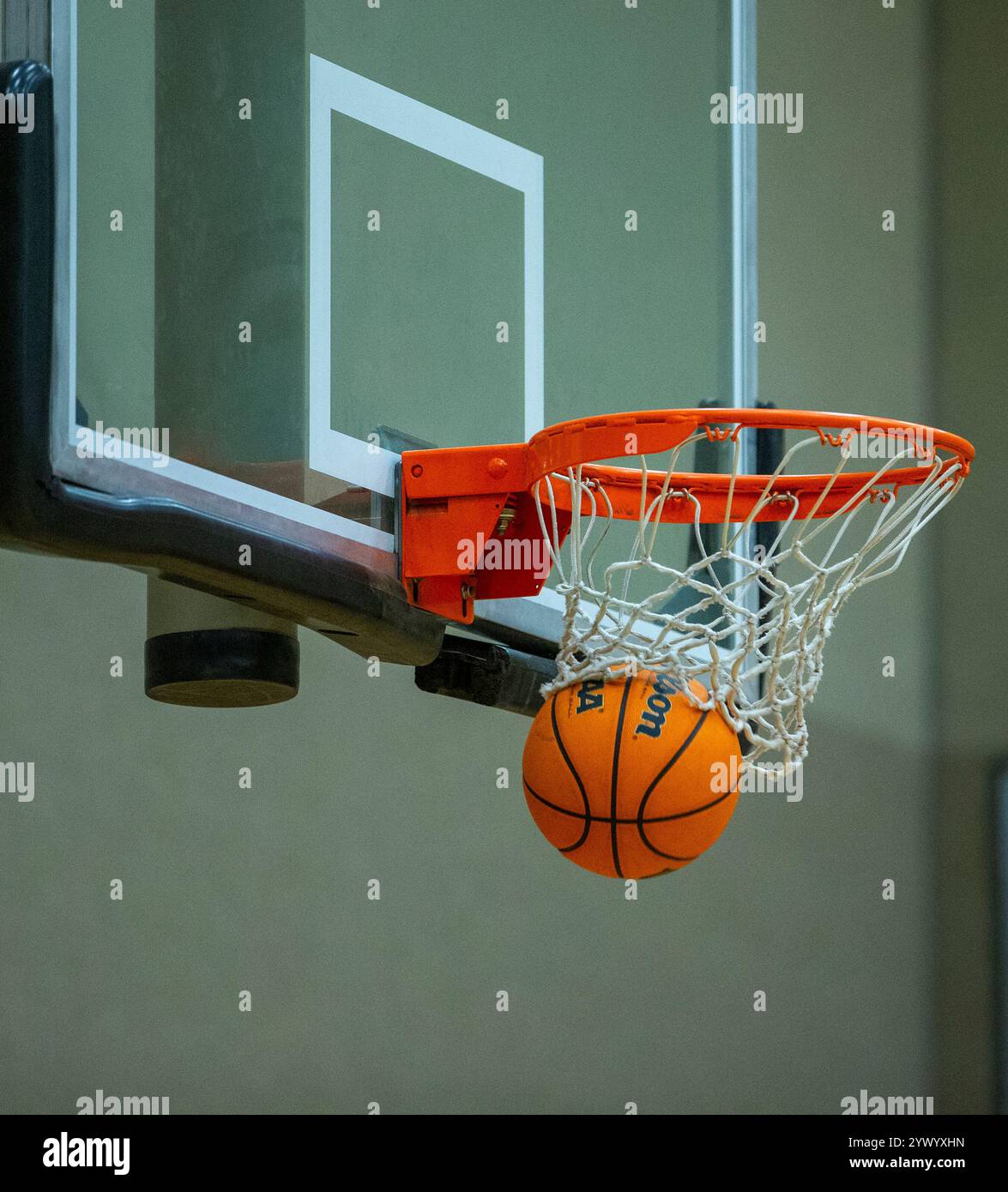 Basketball going through a hoop Stock Photo - Alamy