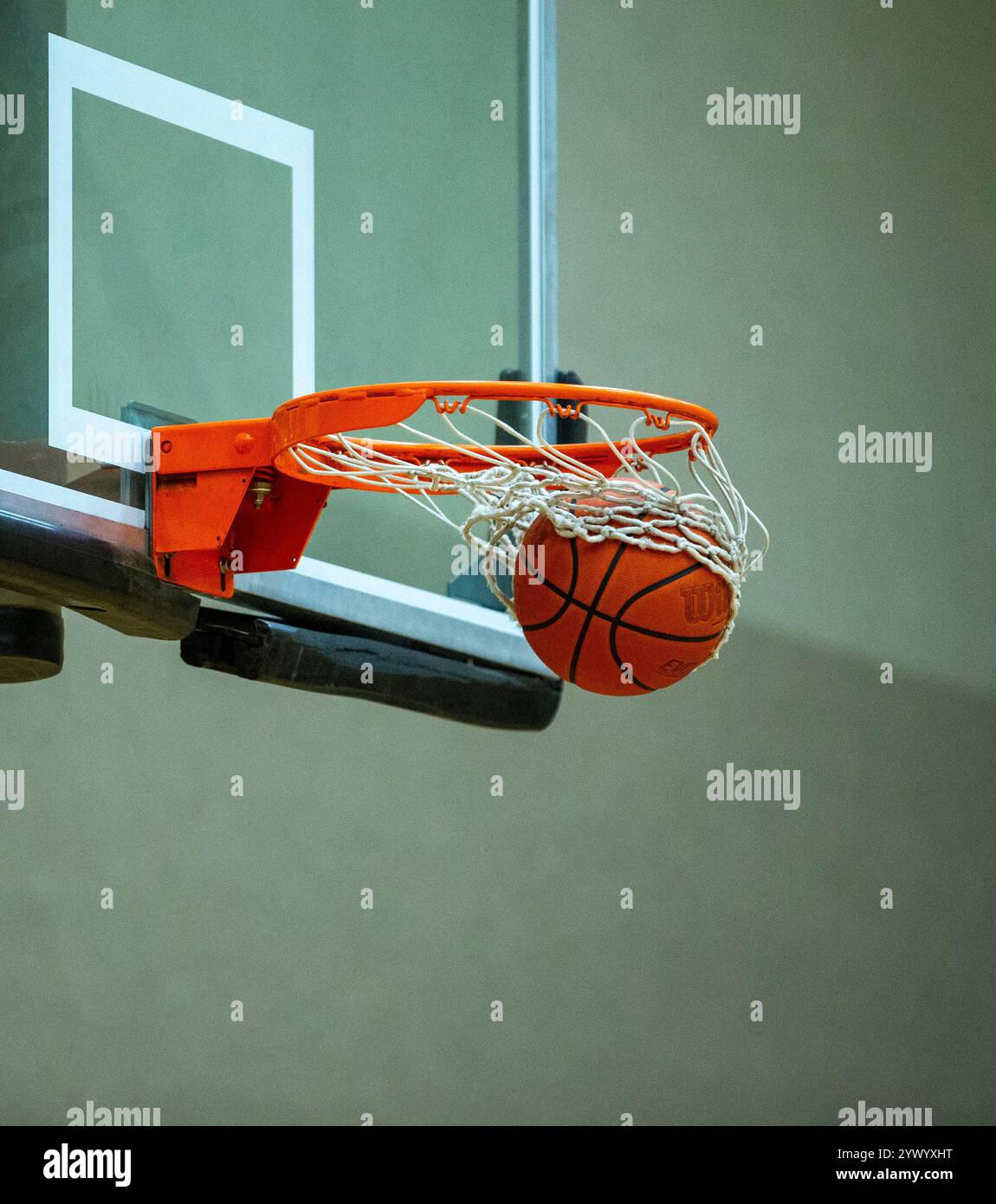 Basketball going through a hoop Stock Photo - Alamy