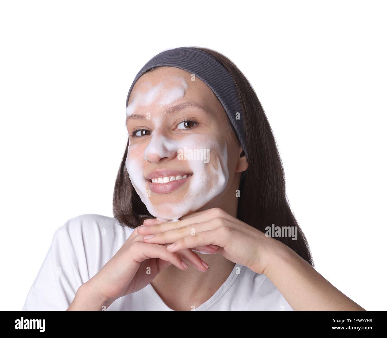 Teenage girl washing her face with cleanser on white background ...