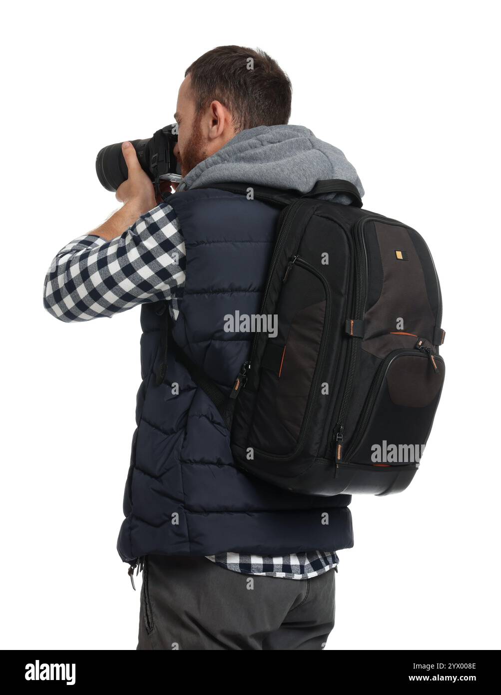 Photographer with backpack and camera taking picture on white ...
