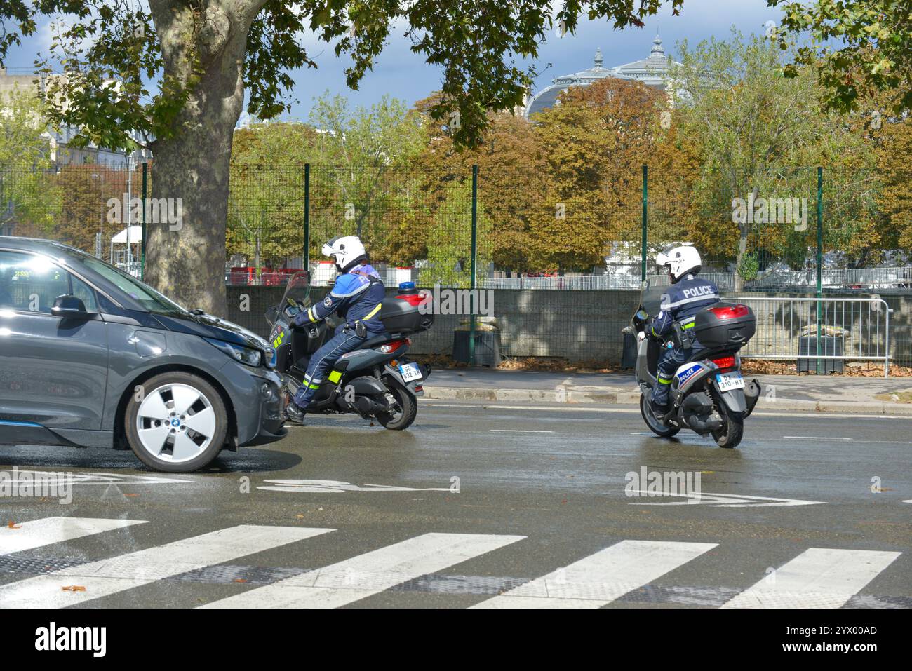 Two french police officers on scooters wait at an intersection in Paris ...