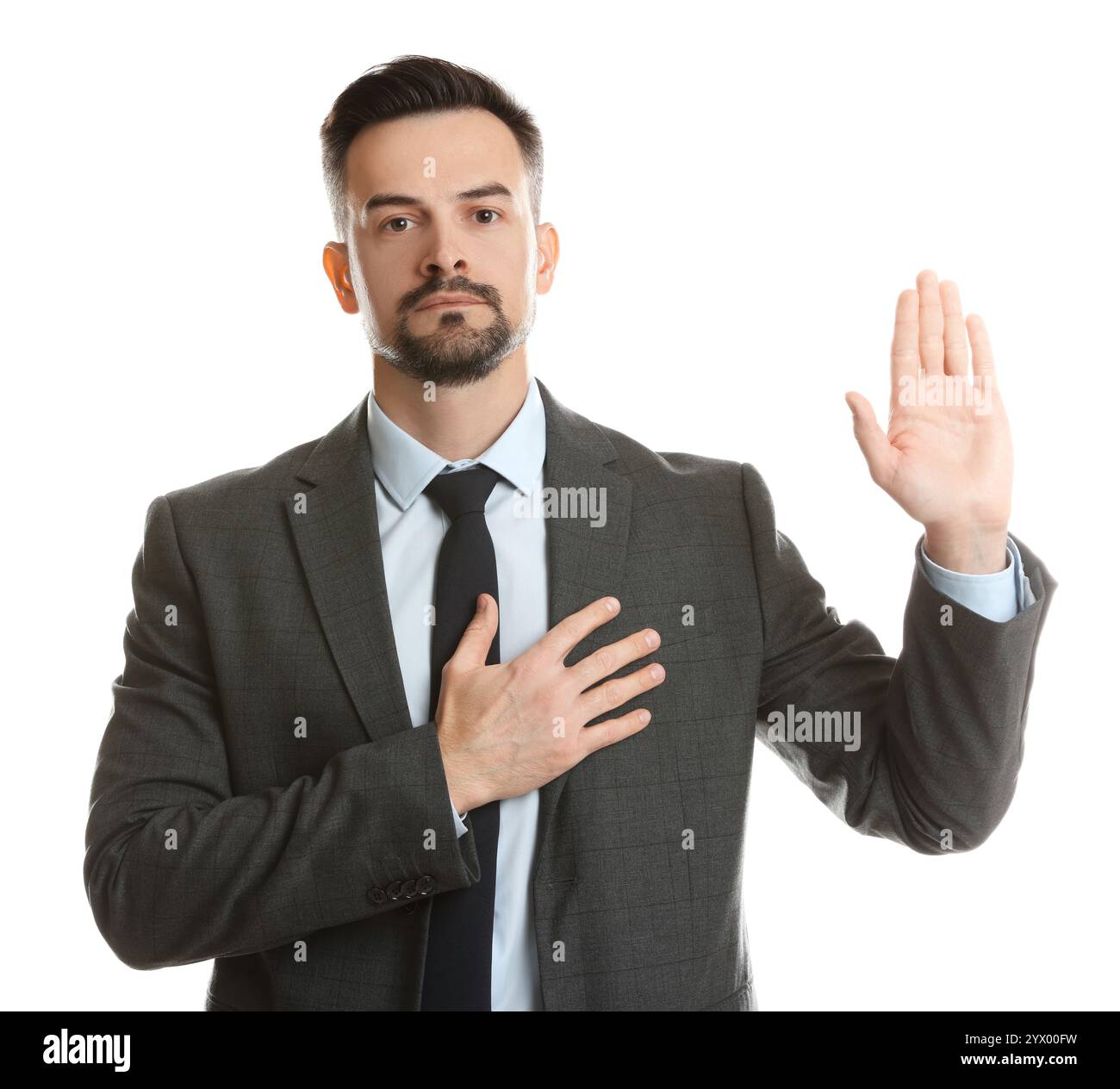 Man making promise with raised hand on white background. Oath gesture ...
