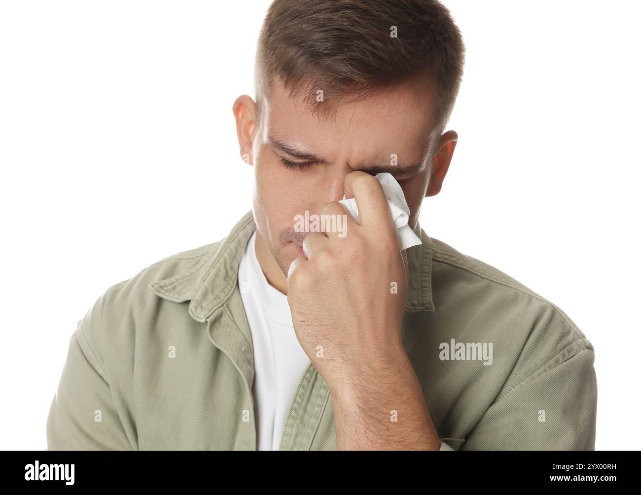Crying man wiping tears with tissue on white background Stock Photo - Alamy