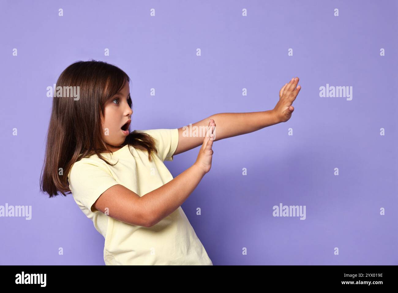 Portrait of scared little girl on violet background Stock Photo - Alamy