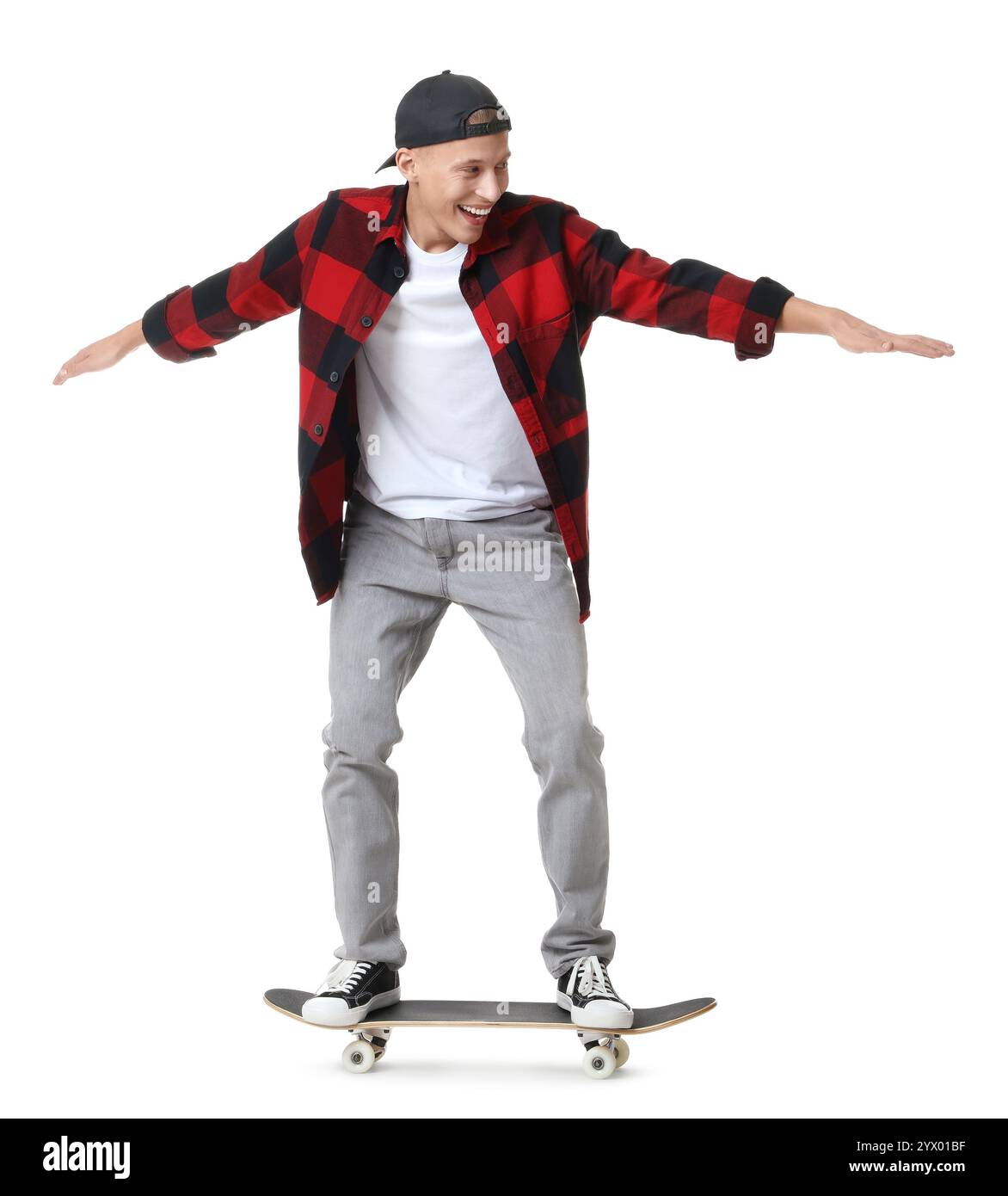Happy man riding skateboard on white background Stock Photo - Alamy