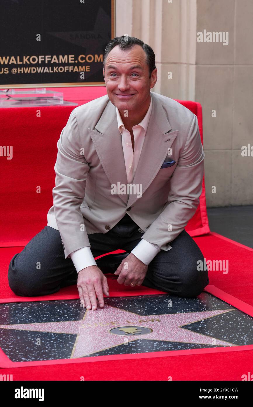 Jude Law poses with his new star at a ceremony honoring him on the ...